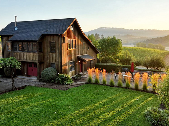 Rustic barn architecture houses modern winemaking where tradition and innovation create liquid poetry together.
