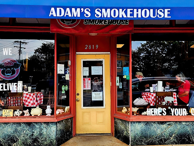 That red storefront isn't just catching your eye – it's practically waving you in for some serious barbecue magic.