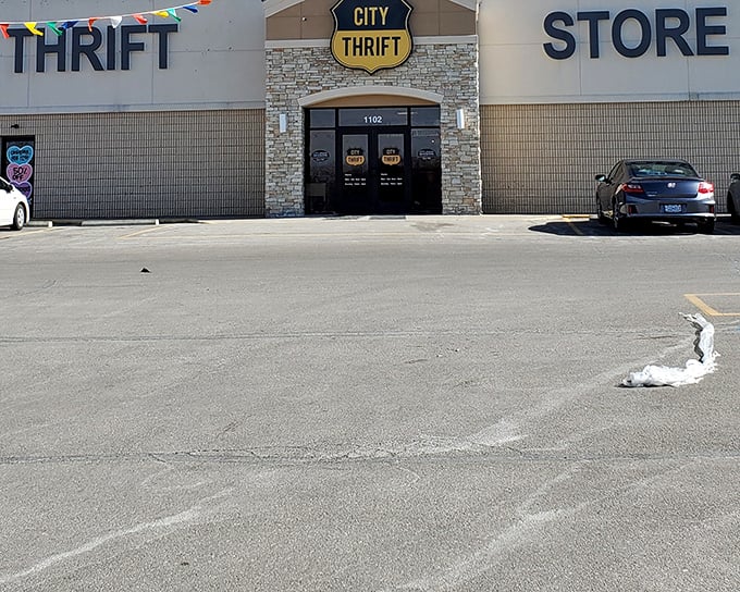 City Thrift's stone-accented entrance stands like a gateway to bargain heaven, complete with festive flags to welcome treasure hunters.