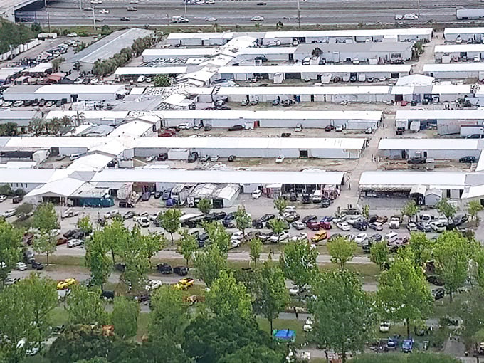 This aerial view reveals shopping paradise - acres of vendor booths creating a treasure hunter's dream landscape.