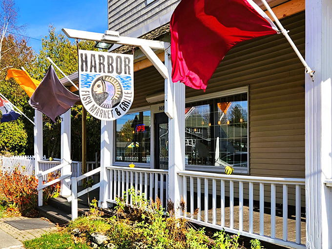 This charming New England-style cottage whispers "fresh fish ahead" with every weathered board and nautical flag.