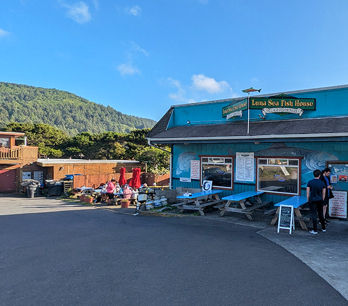 Nestled against forested hills, this ocean-blue gem serves coastal comfort with mountain backdrop magic.