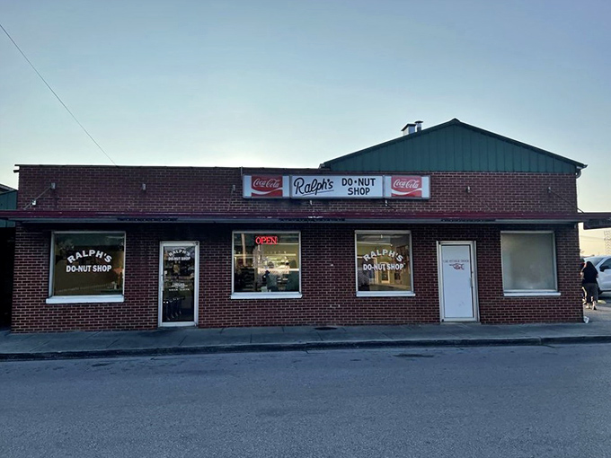 Red brick authenticity with vintage Coca-Cola flair - this is where donut tradition lives and breathes daily.