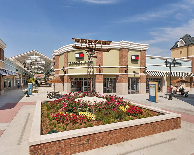 Brick pathways and flowering gardens create a charming village atmosphere where bargain hunting feels like a pleasant stroll.