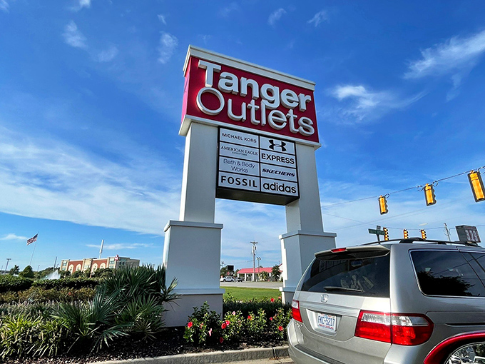 That towering Tanger sign isn't just advertising—it's a promise of retail therapy waiting just beyond those traffic lights.