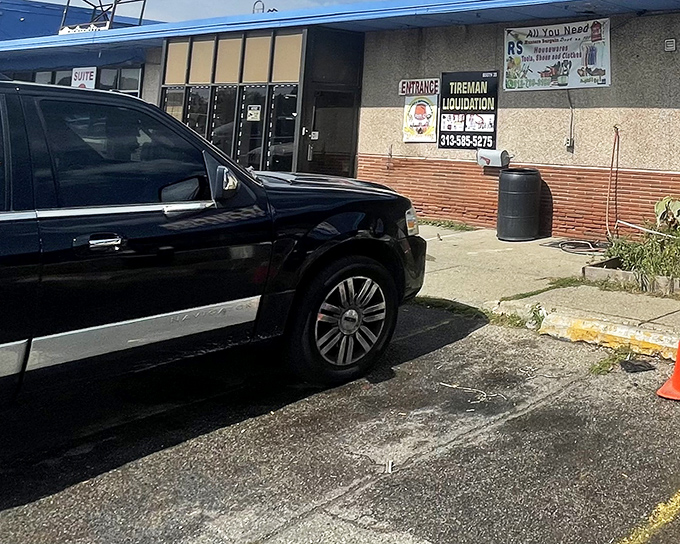 Tireman's entrance beckons like a portal to bargain paradise &ndash; liquidation signs and all, baby!