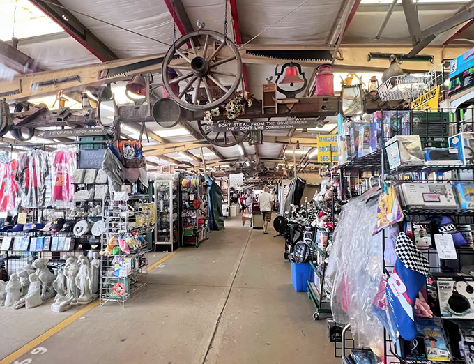 At Traders World, even the ceiling tells a story! Wagon wheels and vintage treasures hang overhead while shoppers hunt below.