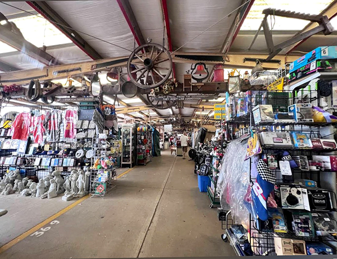 Inside this flea market wonderland, vintage wagon wheels hang overhead like rustic chandeliers from yesteryear.