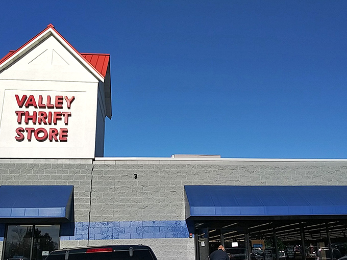 Valley Thrift's bold red sign against clear blue skies &ndash; a beacon of hope for your wallet and your home decorating dreams.