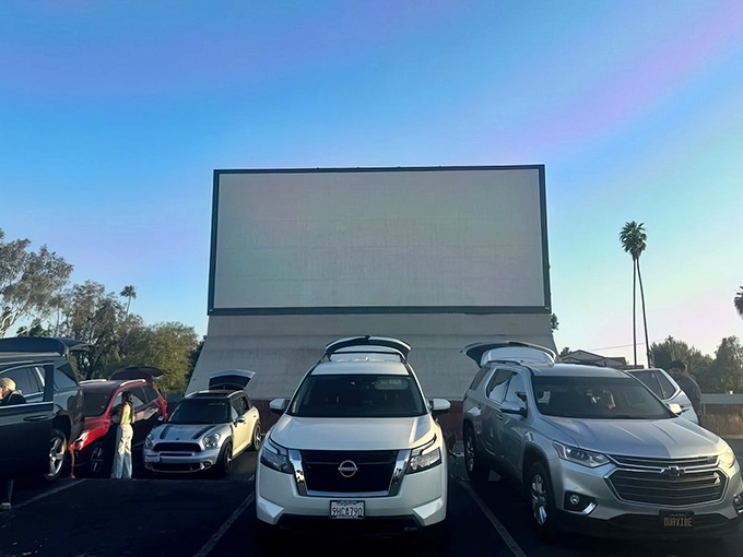 "Drive-in tailgating" takes on new meaning at Van Buren, where SUV owners transform trunks into premium viewing lounges as palm trees stand guard.