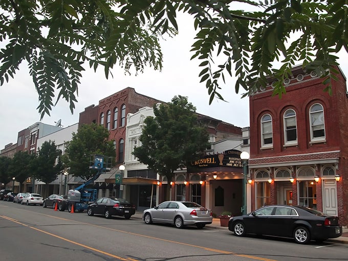 Evening lights illuminate Adrian's welcoming main street, where local businesses create a cozy community gathering place for neighbors.