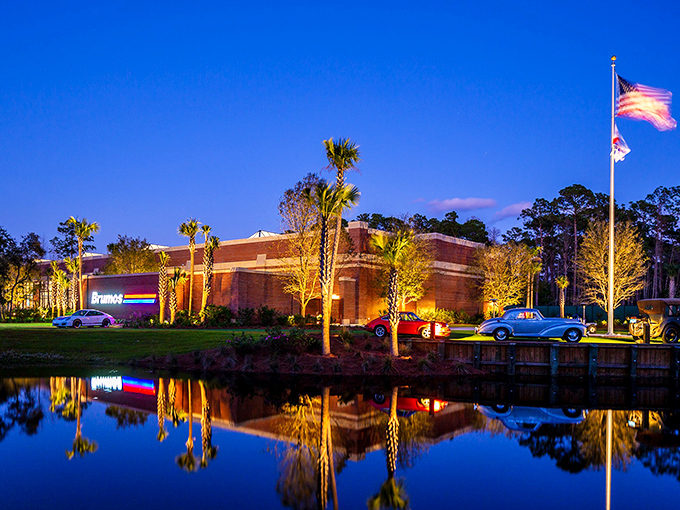 Evening light transforms this museum into something magical, where racing dreams reflect in still waters like memories.