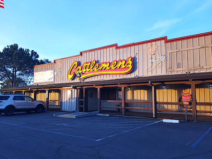 The glowing Cattlemen's sign beckons hungry travelers like a meaty lighthouse guiding you to steak salvation.