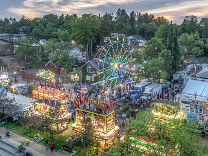As twilight settles over Chagrin Falls, the town transforms into a magical scene with carnival lights reflecting off the water.