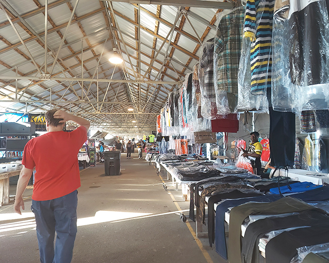 Rows of clothing hang like colorful flags announcing victory over department store prices everywhere.