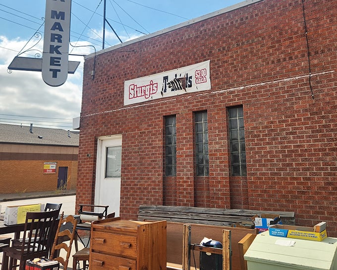 Wooden furniture and vintage treasures create an outdoor display that beckons serious treasure hunters inside.