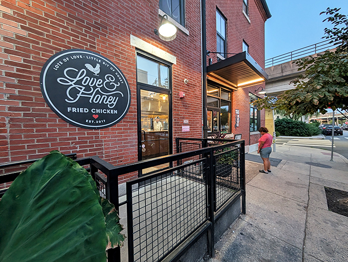 The evening glow on Love & Honey's facade is like nature's way of highlighting where to find Philly's most crave-worthy fried chicken.