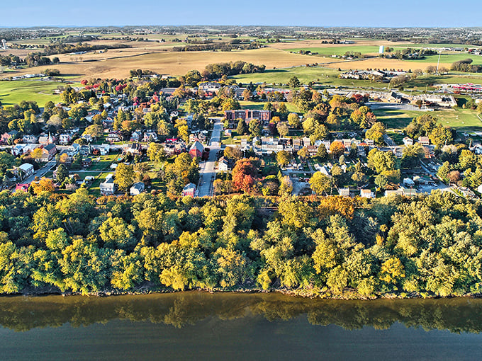 This sleepy river town awakens with autumn's brush, painting every tree in shades of pure contentment.