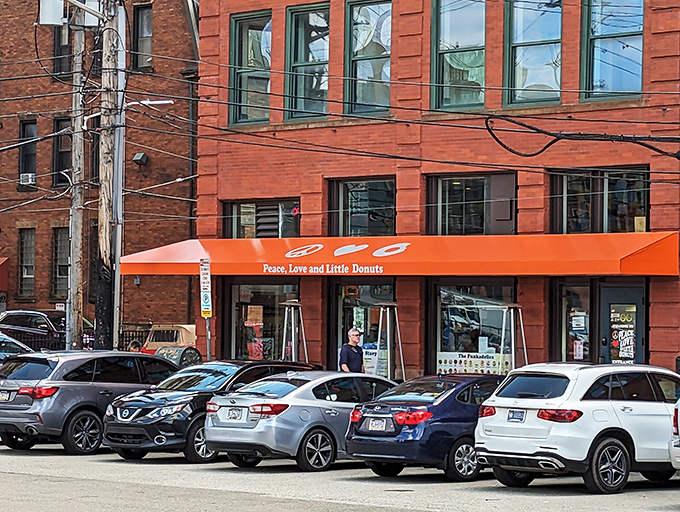 The orange storefront practically glows with warmth, much like the mini donuts waiting inside.