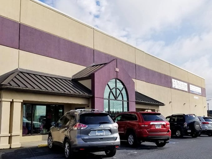 The purple accent wall adds a touch of royal flair to this thrift kingdom of neatly arranged treasures.