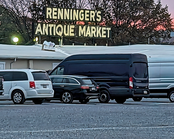 The iconic Renningers sign glows against the twilight sky, beckoning early birds and night owls alike to this vintage wonderland.