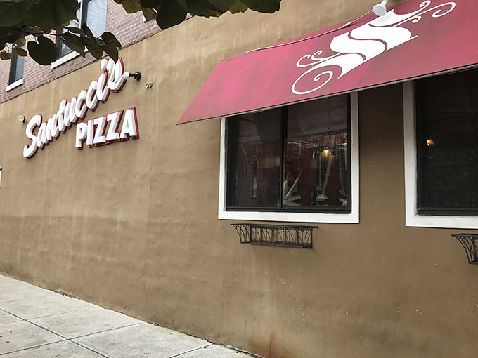 That iconic burgundy awning signals you've arrived at square pizza paradise &ndash; where sauce-on-top creates flavor that defies gravity.