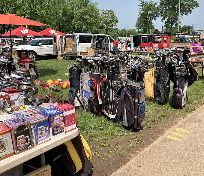 Golf bags cluster like old friends reuniting, each one holding stories of fairways past.