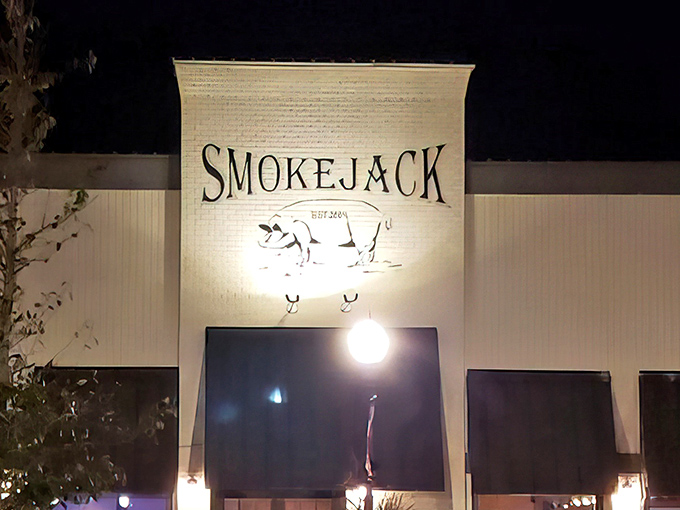 Evening lights illuminate a suburban gem where traditional smoking meets contemporary style with delicious results.