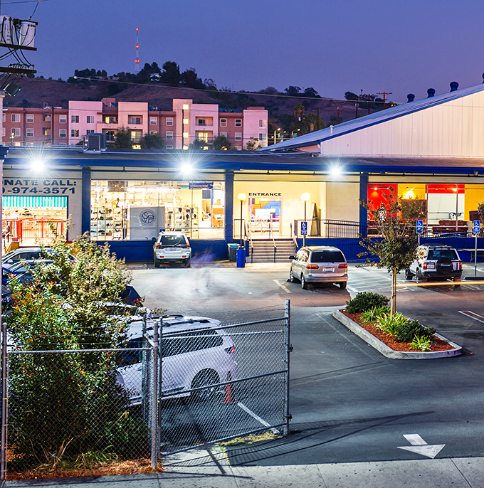 Evening light makes this thrift store glow like a beacon for bargain hunters seeking their next perfect find.