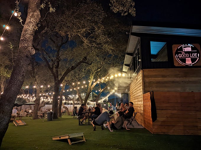Twinkling lights and Texas oaks create magic at The Good Lot, where conversations flow as freely as the craft beer.