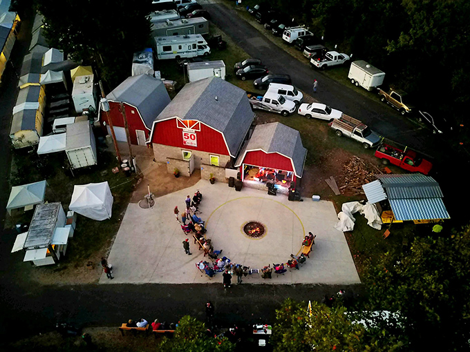 From above, the market's red barns and gathering spaces reveal themselves like a miniature village dedicated to the art of the deal and community connection.