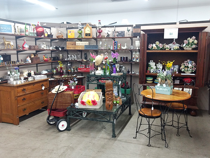 Every shelf tells a story in this booth, where vintage treasures await new homes. That red wagon? Just begging for a second childhood.