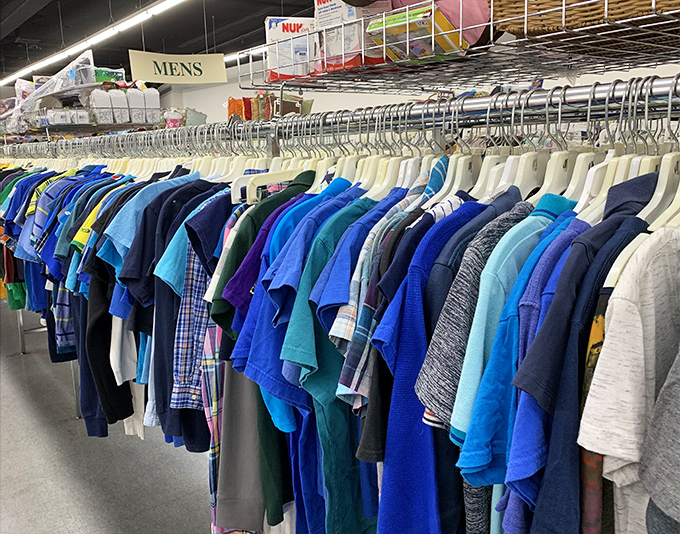 The men's section: organized by color like a chef's mise en place. Blues and greens create a visual symphony that makes finding your size surprisingly painless.