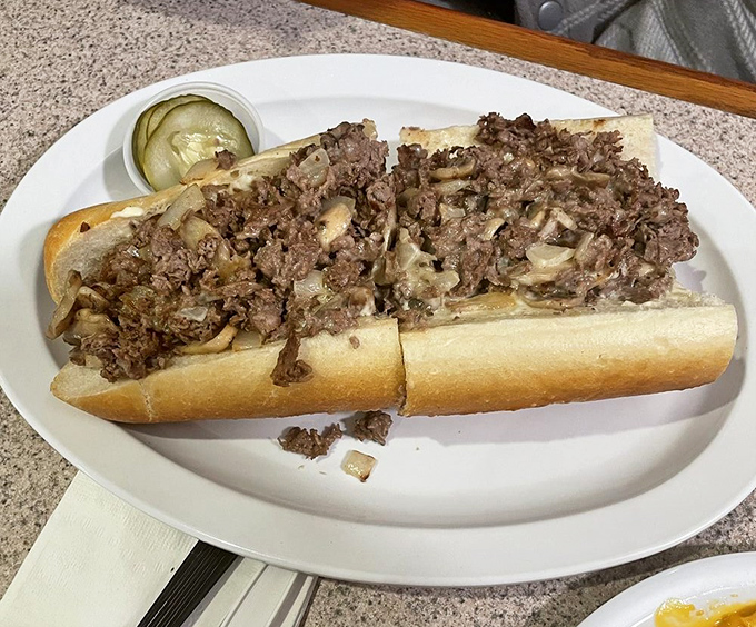 Behold the masterpiece that'll haunt your dreams - perfectly seasoned steak swimming in melted cheese bliss.