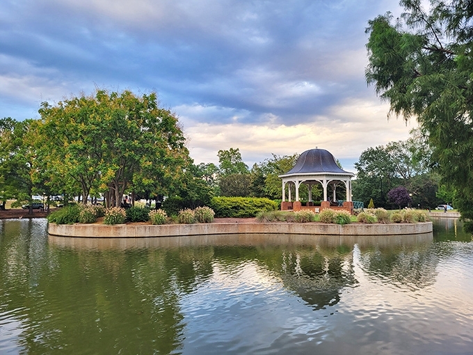 Cleveland Park's serene gazebo reflects perfectly in still waters, creating the kind of symmetry that makes photographers swoon and retirement brochures sell themselves.