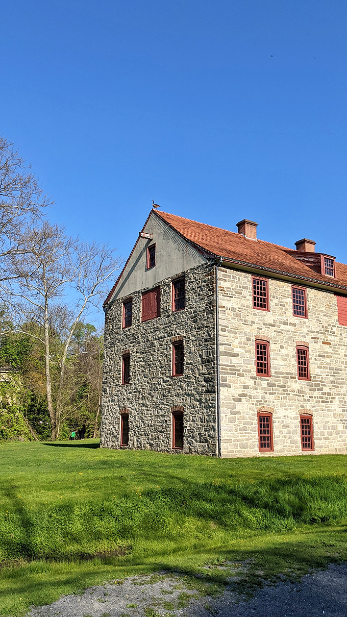 This sturdy stone structure has weathered centuries of Pennsylvania seasons, its red-trimmed windows like eyes that have witnessed the full arc of American history.