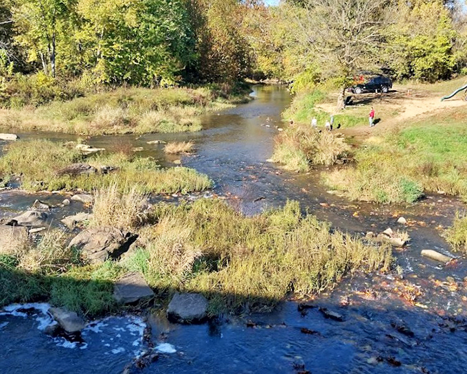 Big Raccoon Creek meanders beneath the bridge, its gentle current and rocky bed creating nature's soundtrack&mdash;the original noise-canceling experience. 