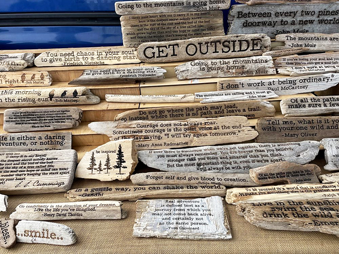 Words of wisdom etched into driftwood create a wall of inspiration. John Muir would approve of these artistic reminders to "GET OUTSIDE."