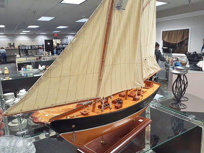 This model sailboat isn't just decorative&mdash;it's someone's forgotten maritime dream waiting for your living room to become its harbor.