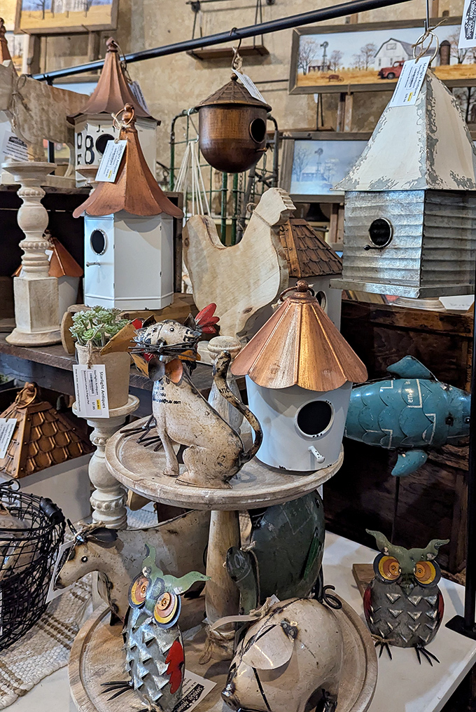 A parliament of birdhouses stands ready for feathered tenants. Each one tells a different architectural story from copper-topped elegance to rustic charm.