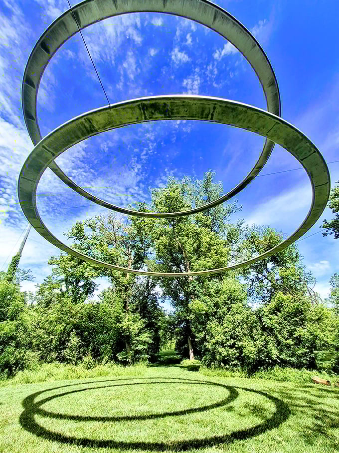 Look up and question everything. These suspended metal rings transform with changing light, creating a cosmic portal right in the heart of Indiana.