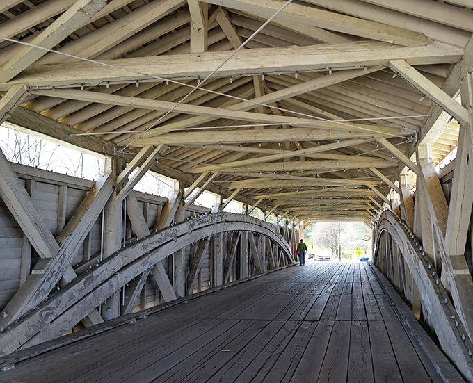Beneath the weathered beams, a cathedral of craftsmanship reveals itself. Each wooden joint tells a story of Pennsylvania ingenuity that's stood for nearly two centuries.
