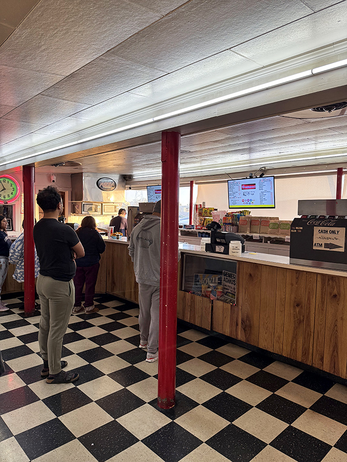 The snack bar's checkered floors and red pillars scream nostalgia louder than teenagers at a horror movie.