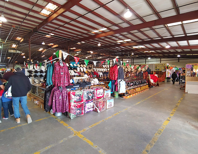 Colorful clothing racks stretch into the distance under industrial ceilings, creating aisles of possibility where fashion finds hide in plain sight.