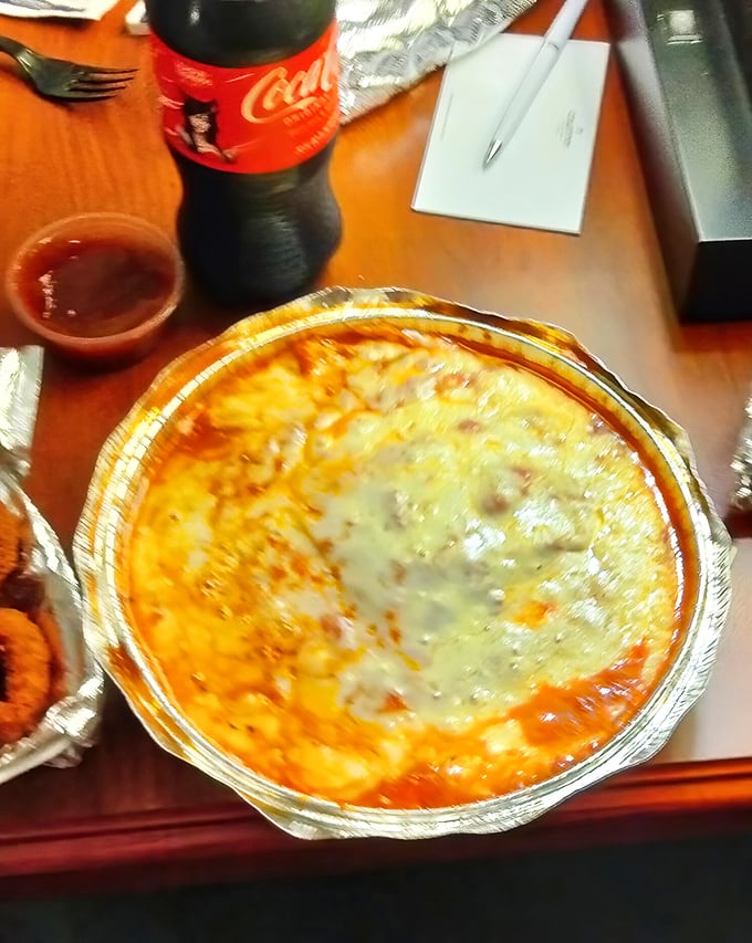 Behold the lasagna in its aluminum chariot, where cheese stretches toward heaven and sauce bubbles like nature's perfect lava.