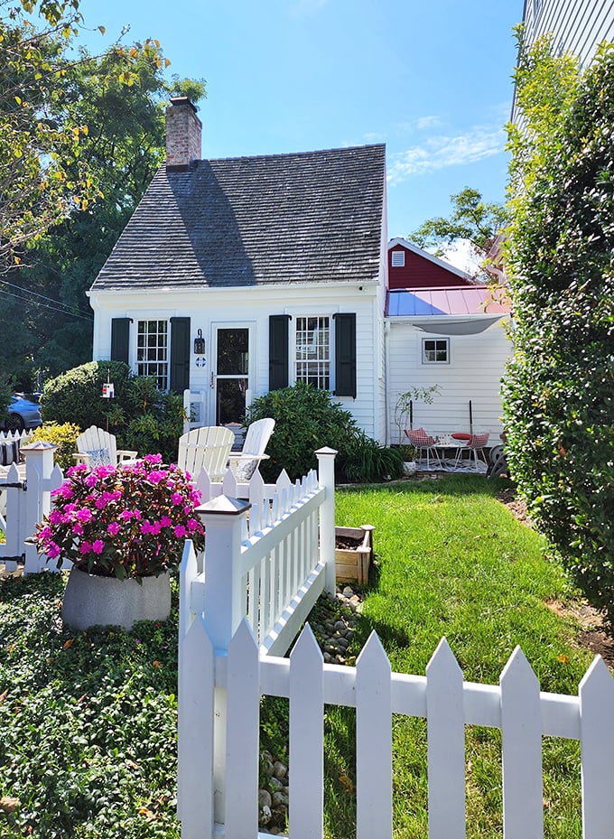 This little white cottage with its picket fence isn't just Instagram-worthy—it's the architectural equivalent of comfort food for the soul.