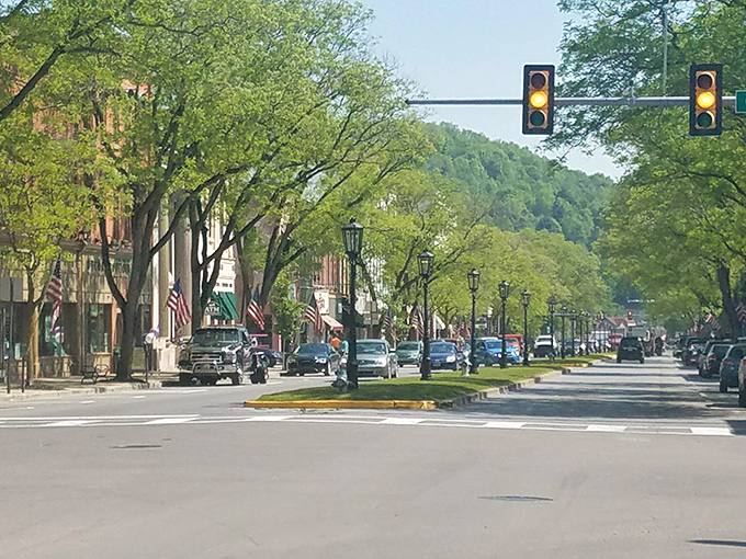 Gas lamps line Wellsboro's picturesque Main Street, where American flags flutter in the breeze and mature trees create a natural canopy over this Norman Rockwell-worthy scene.