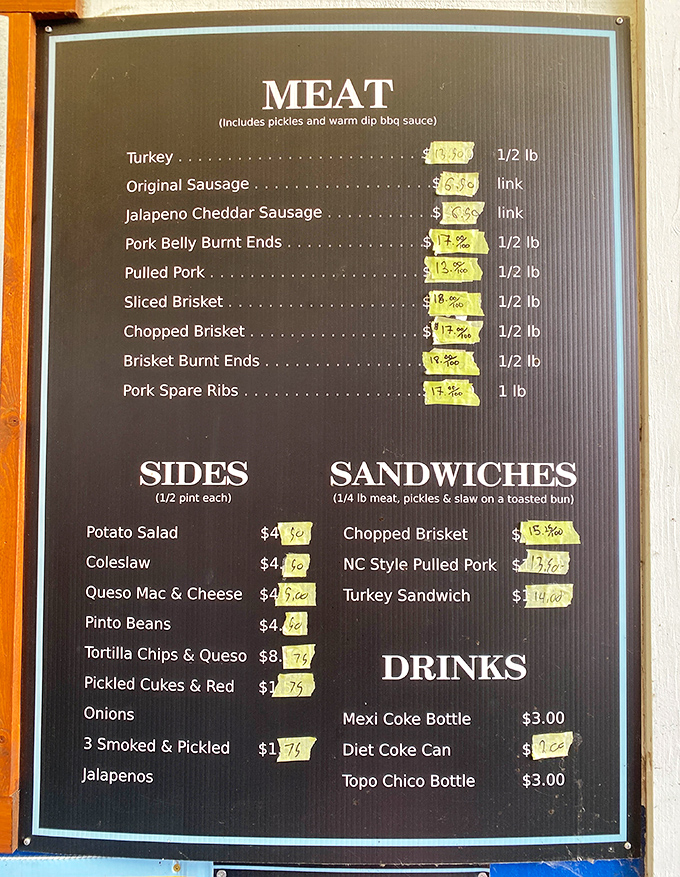 A menu board that reads like poetry to meat lovers. Each yellow price tag represents hours of smoky dedication and countless dreams fulfilled.