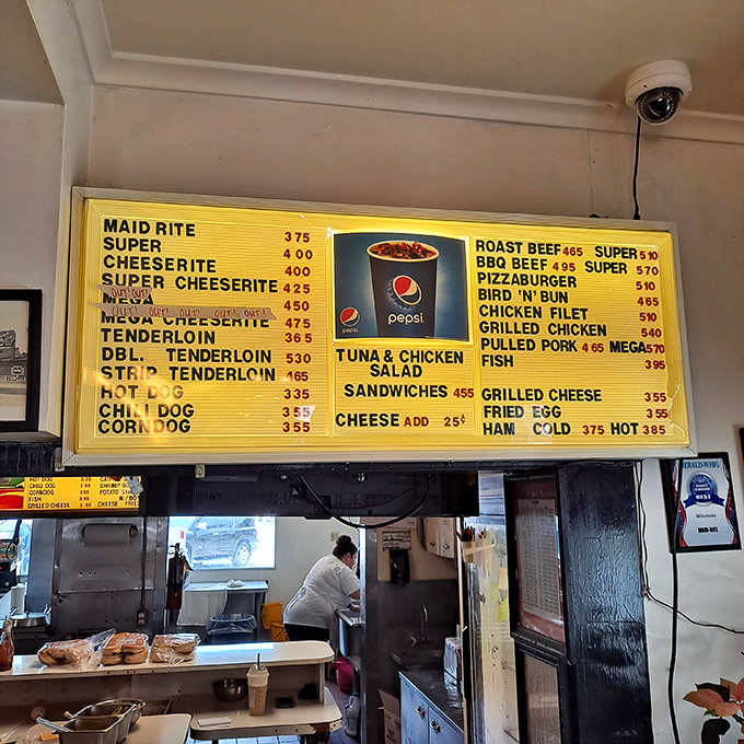 The yellow menu board tells you everything you need to know—simplicity reigns supreme here, with loose meat sandwiches leading the charge.