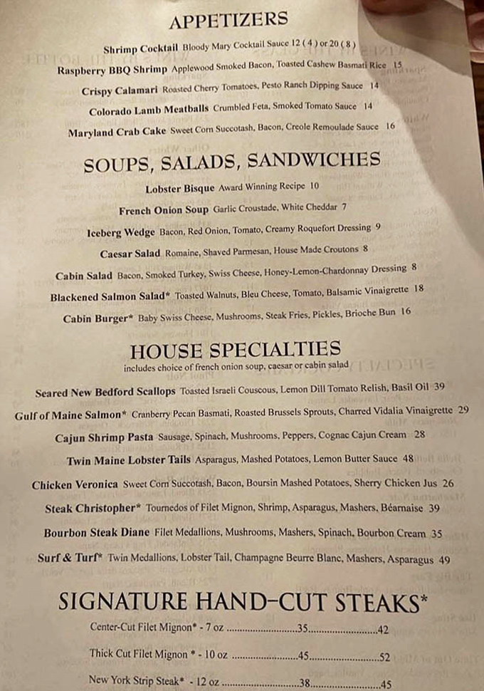 The menu reads like a love letter to carnivores, with that award-winning lobster bisque stealing the spotlight at the top of the soup section.